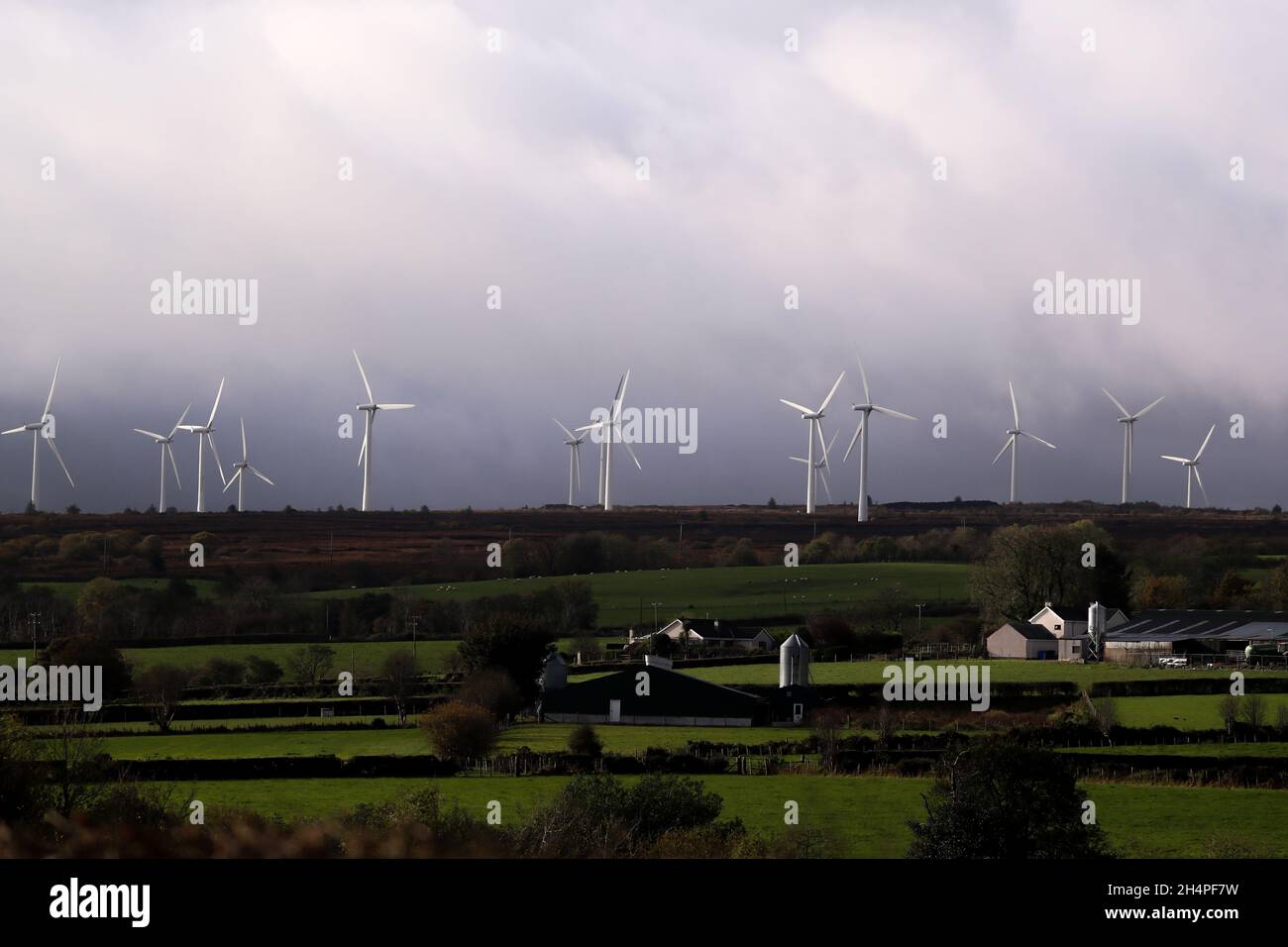Wind turbines on farmland in Co. Derry, Northern Ireland. To reduce ...