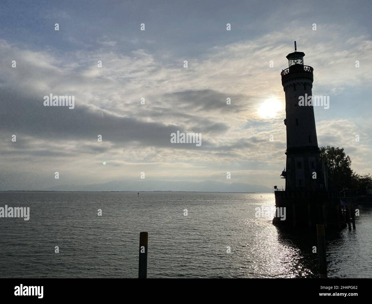 Beautiful view of the Lindau lighthouse in Germany with the sun shining ...