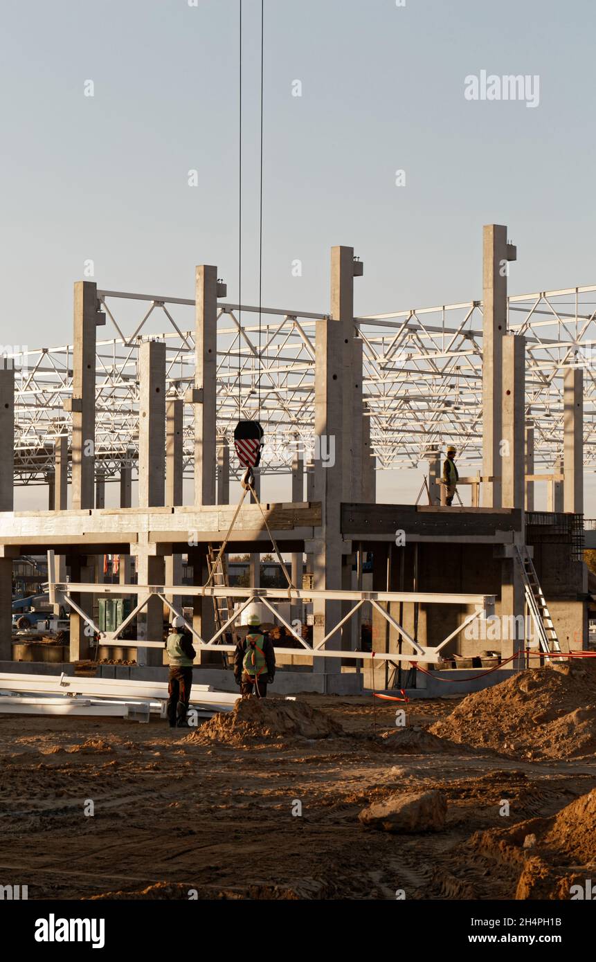Workers build steel construction. Modern industrial building Stock ...