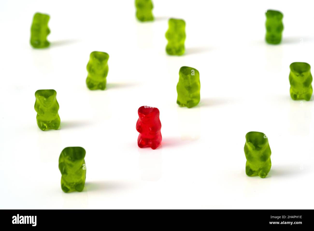 Green gum bears and one red gum bear Stock Photo - Alamy