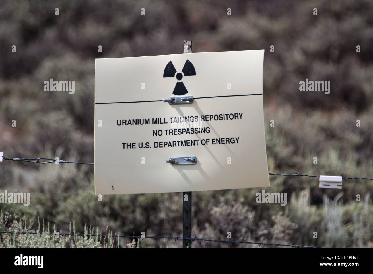 Selective focus shot of uranium mill tailings repository warning sign ...