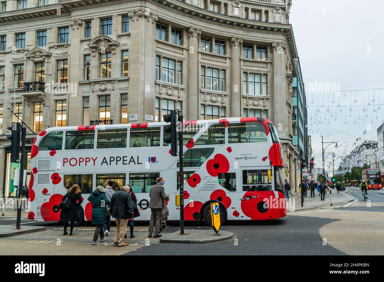 London, UK. 04th Nov, 2021. The poppy bus passes by - Members of the ...