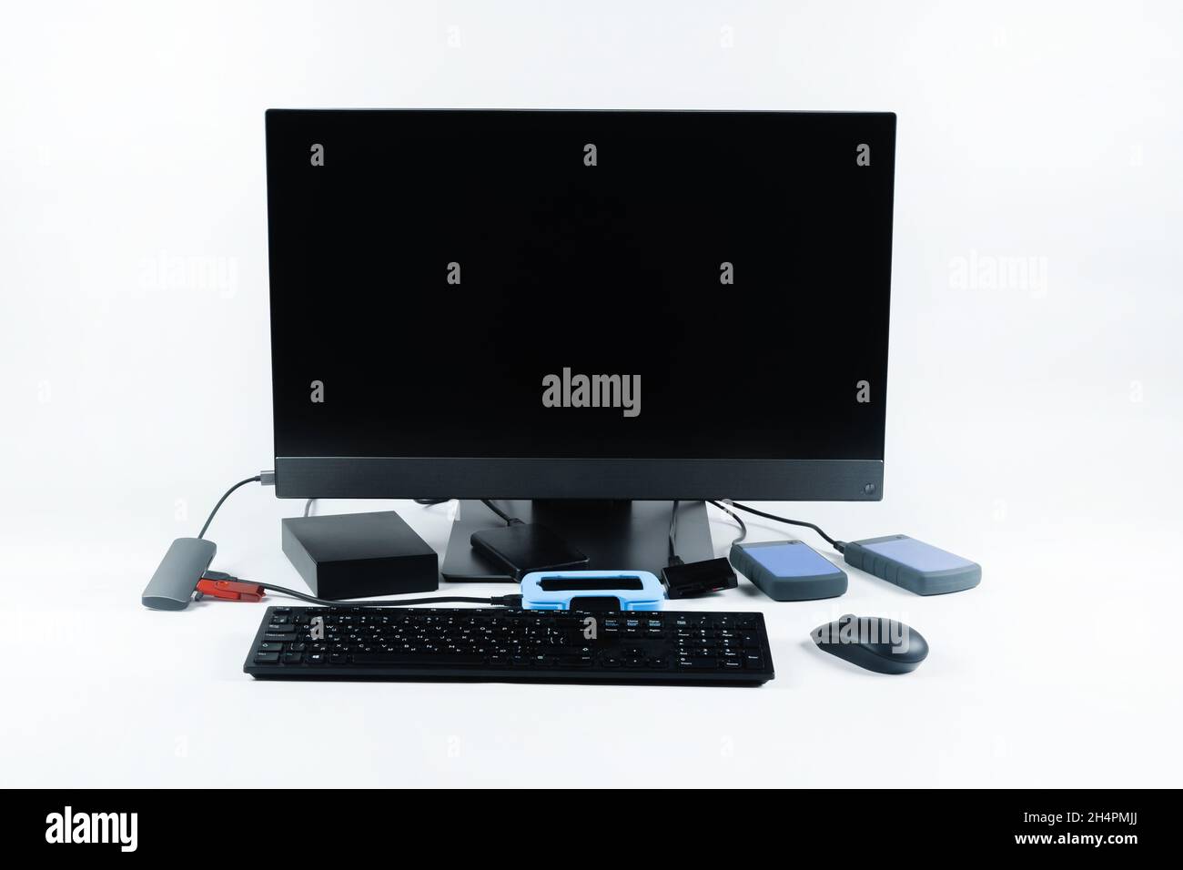 Multiple external hard drives connected to a monoblock on a white ...