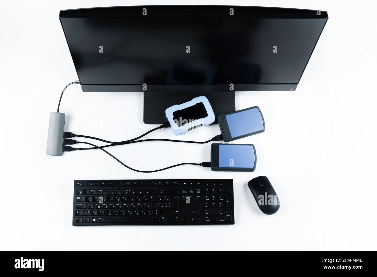 Multiple external hard drives connected to a monoblock on a white ...