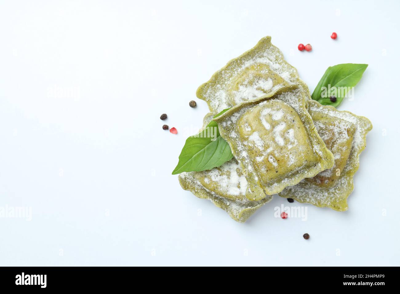 Raw ravioli with spices on white background Stock Photo - Alamy