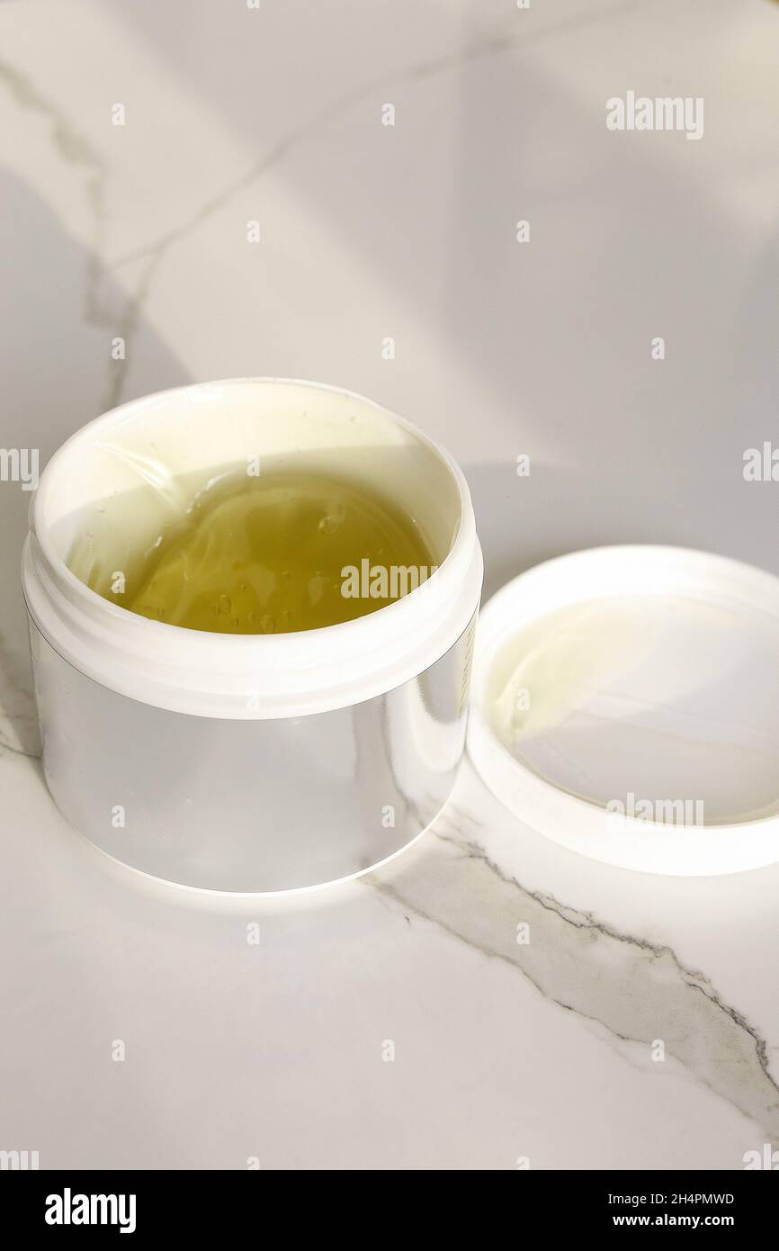 Cosmetic cream container with face or body cream on neutral background ...