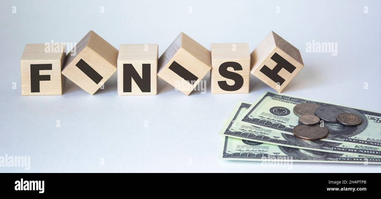 on wooden blocks the text finish and money on a white background Stock ...