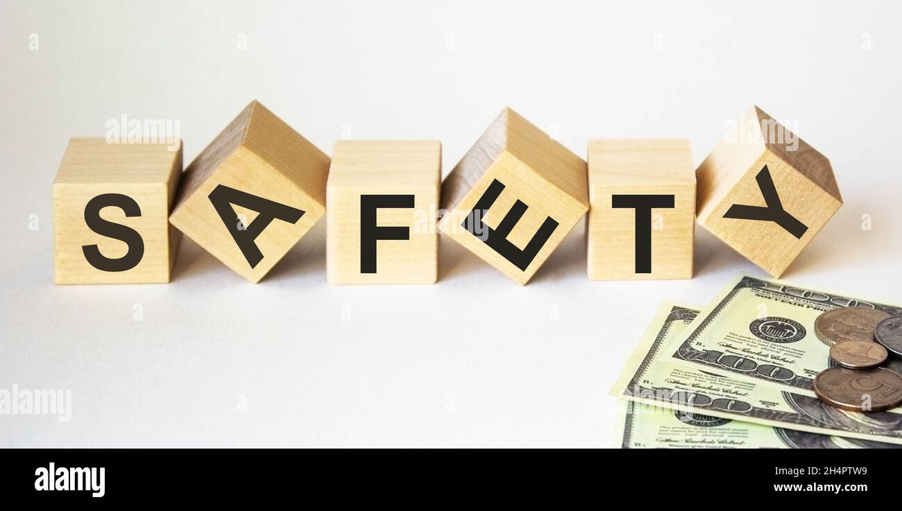 security word written on a wooden block on a white table with dollars ...