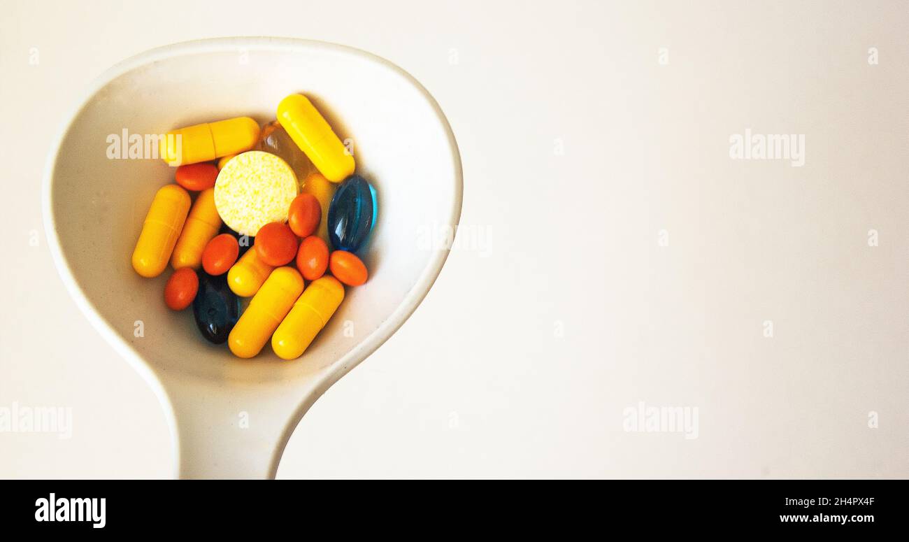 One spoon of medication in front of a White background Stock Photo - Alamy