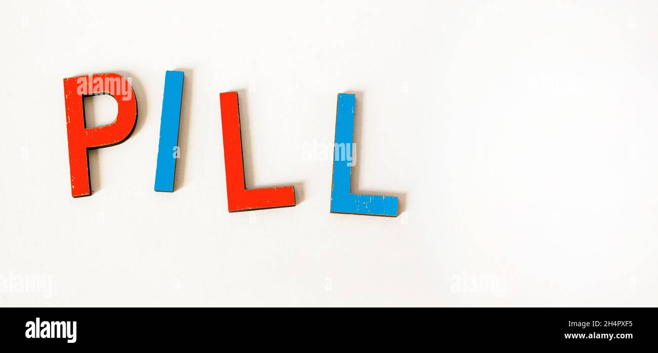 The word PILL consists of wooden colored letters on a white background ...