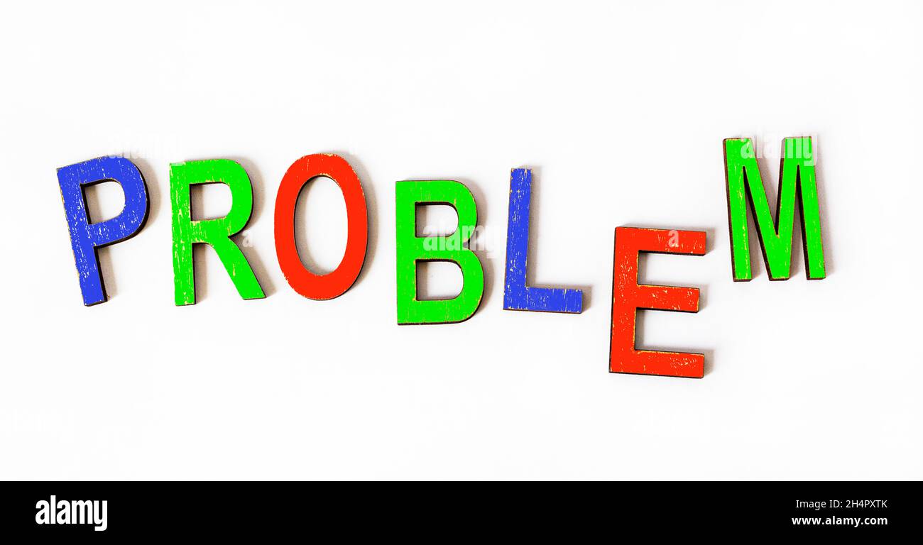 PROBLEM word, written in wooden multicolored letters, on a white ...