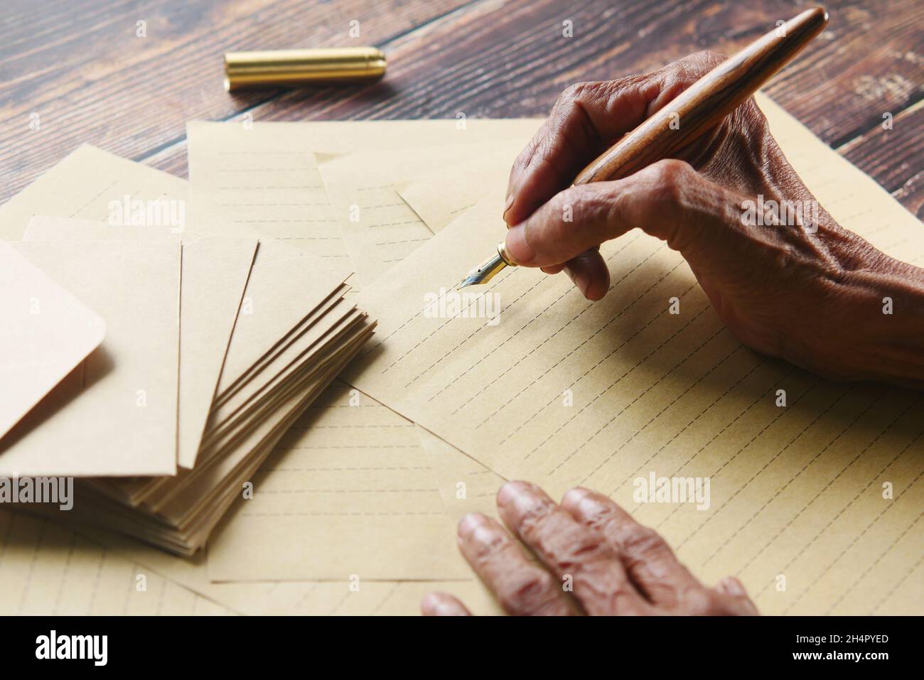 senior women hand writing on a old paper Stock Photo - Alamy