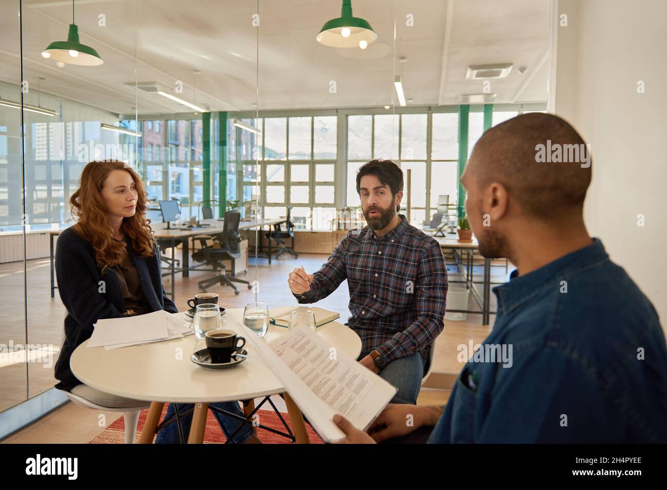 Two colleagues talking drinking coffee hi-res stock photography and ...