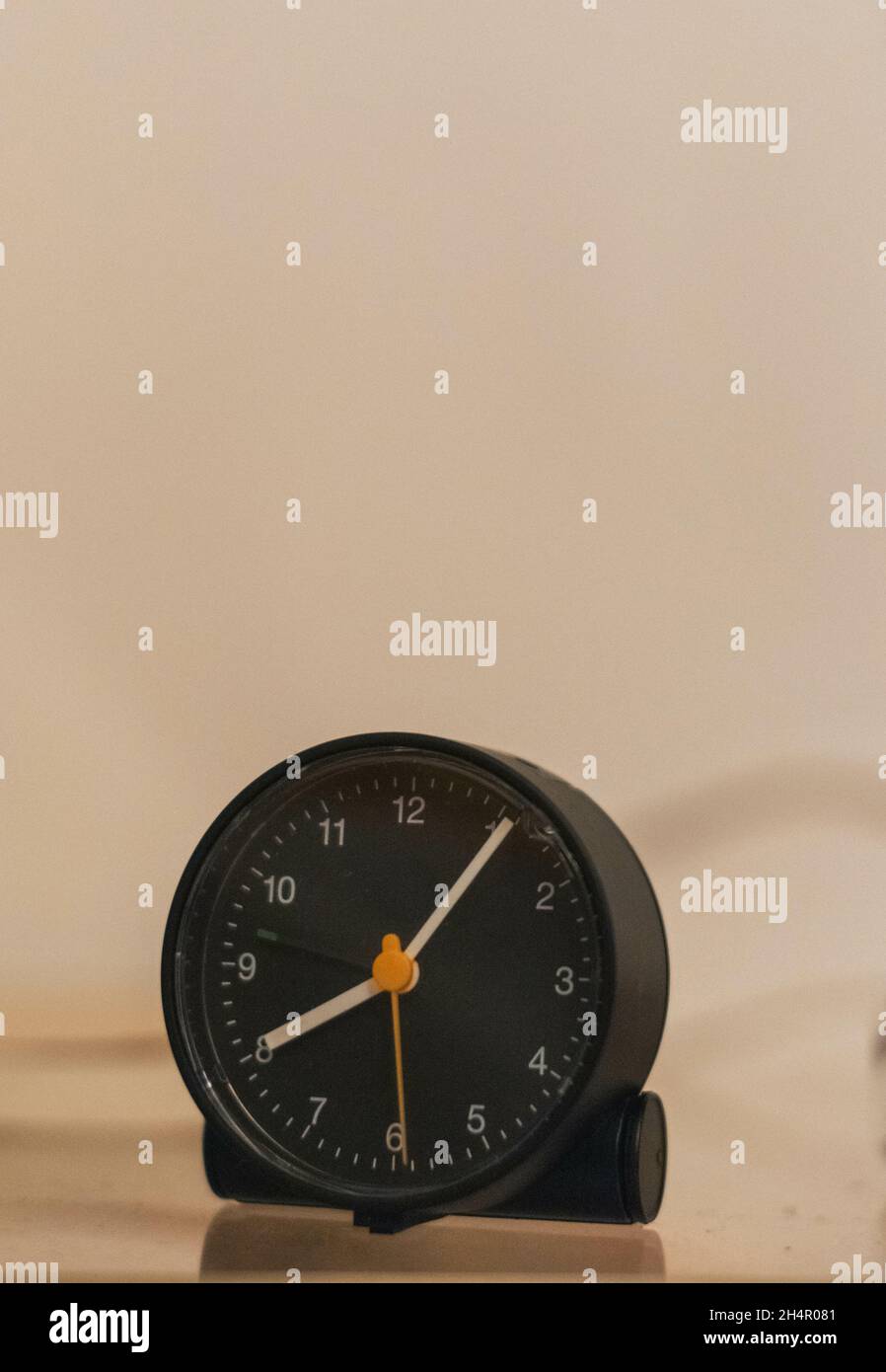 Vertical shot of a black clock in a room Stock Photo - Alamy
