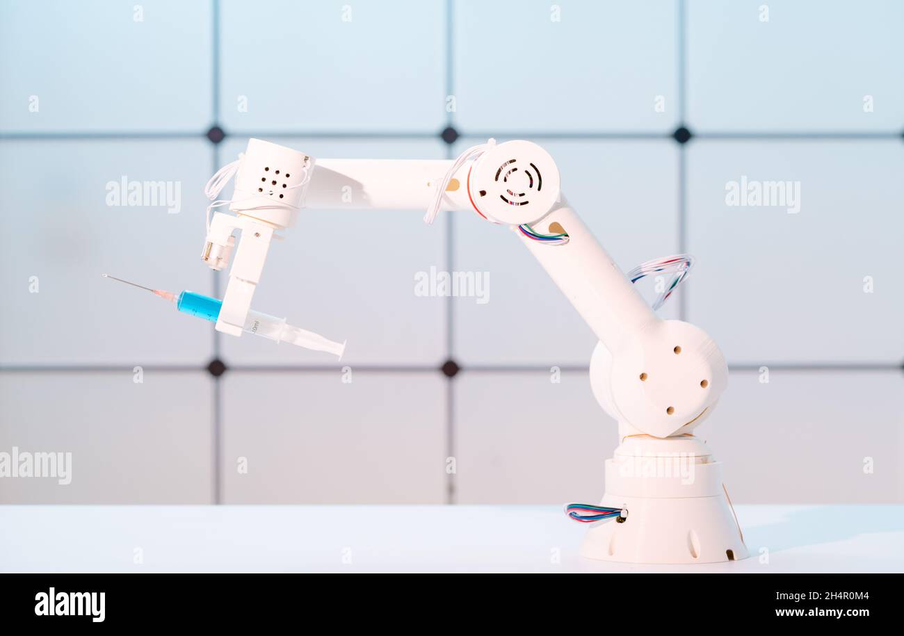 Robot hand with a medical syringe. Future medicine concept using robots ...
