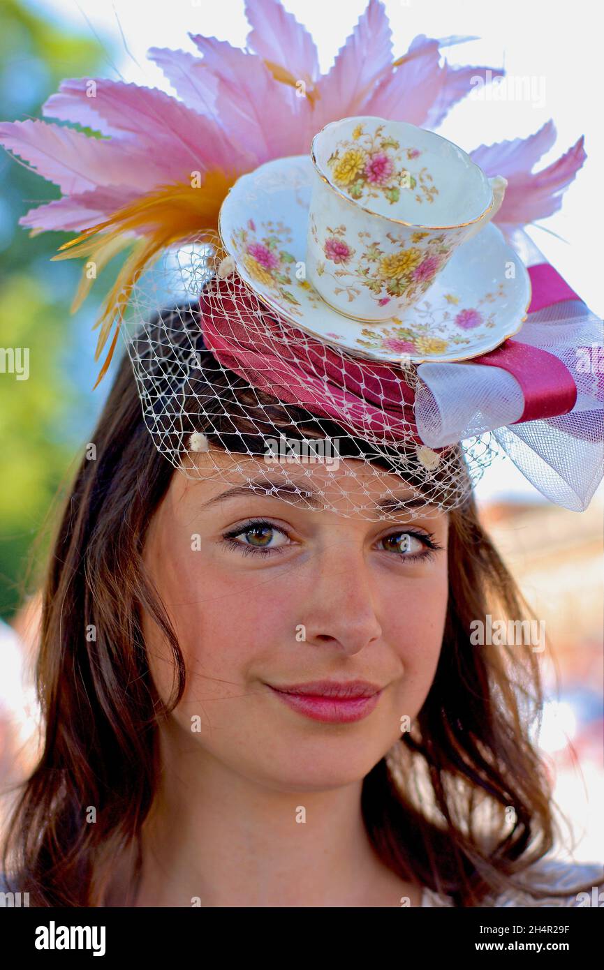 Lady puts on a cup of thea on het hat on Ladies Day Stock Photo - Alamy