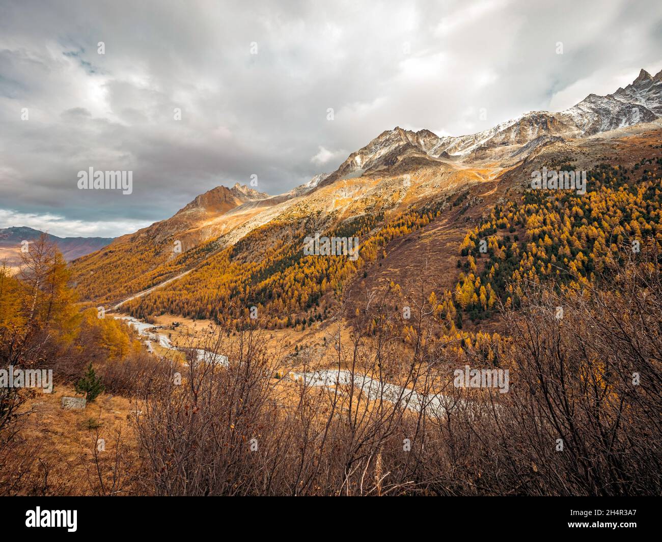 Amazing views over an high alpine valley and snow covered mountains ...