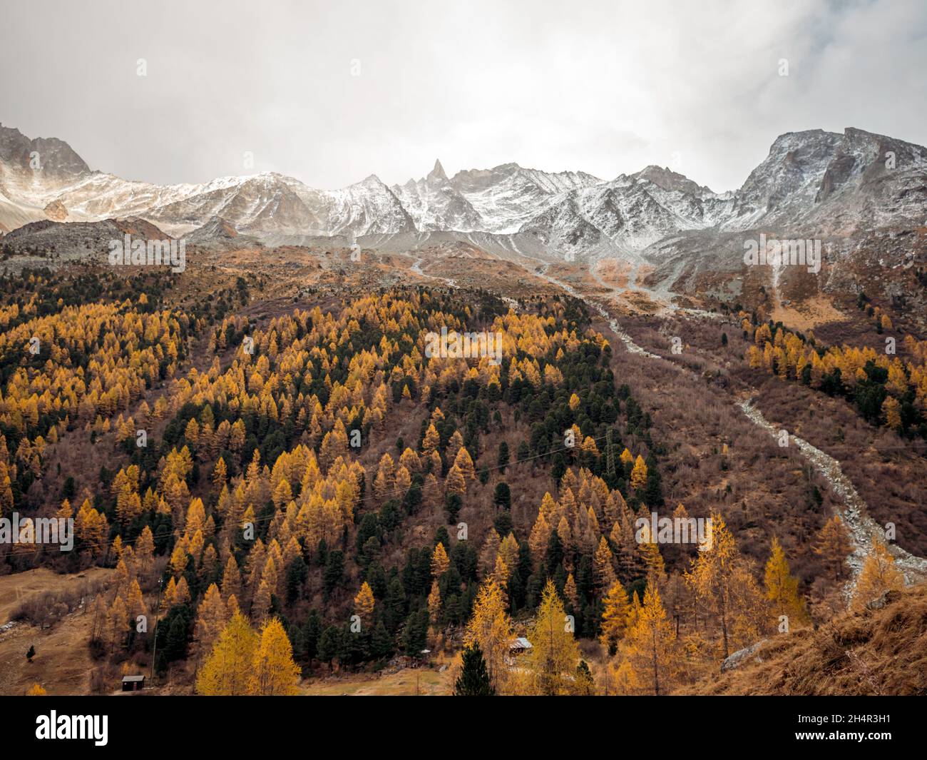 Amazing views over an high alpine valley and snow covered mountains ...