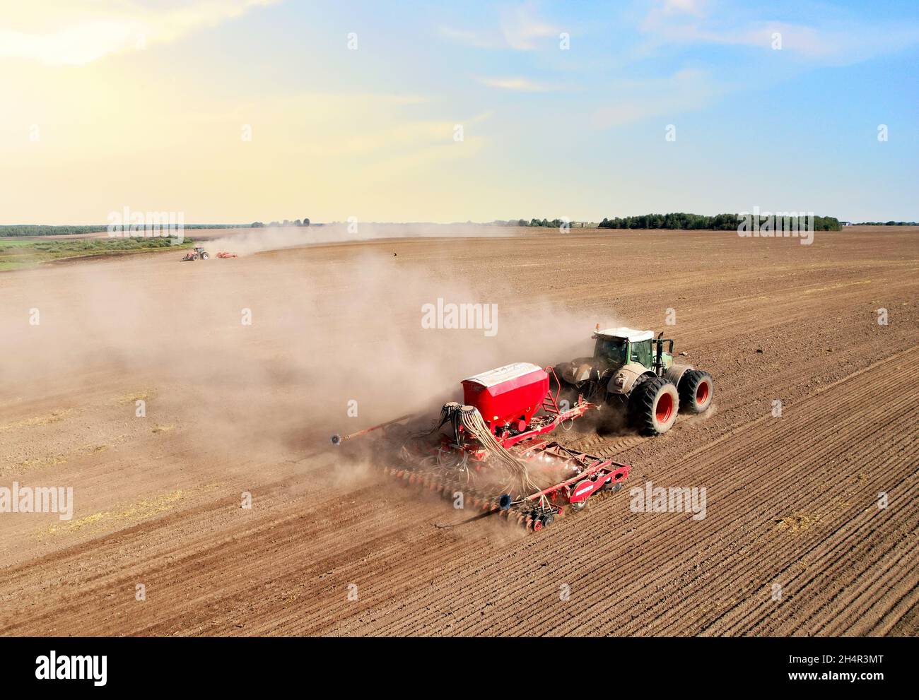 Tractor on sowing seed at field. Farming and seeding machine. Seeds ...