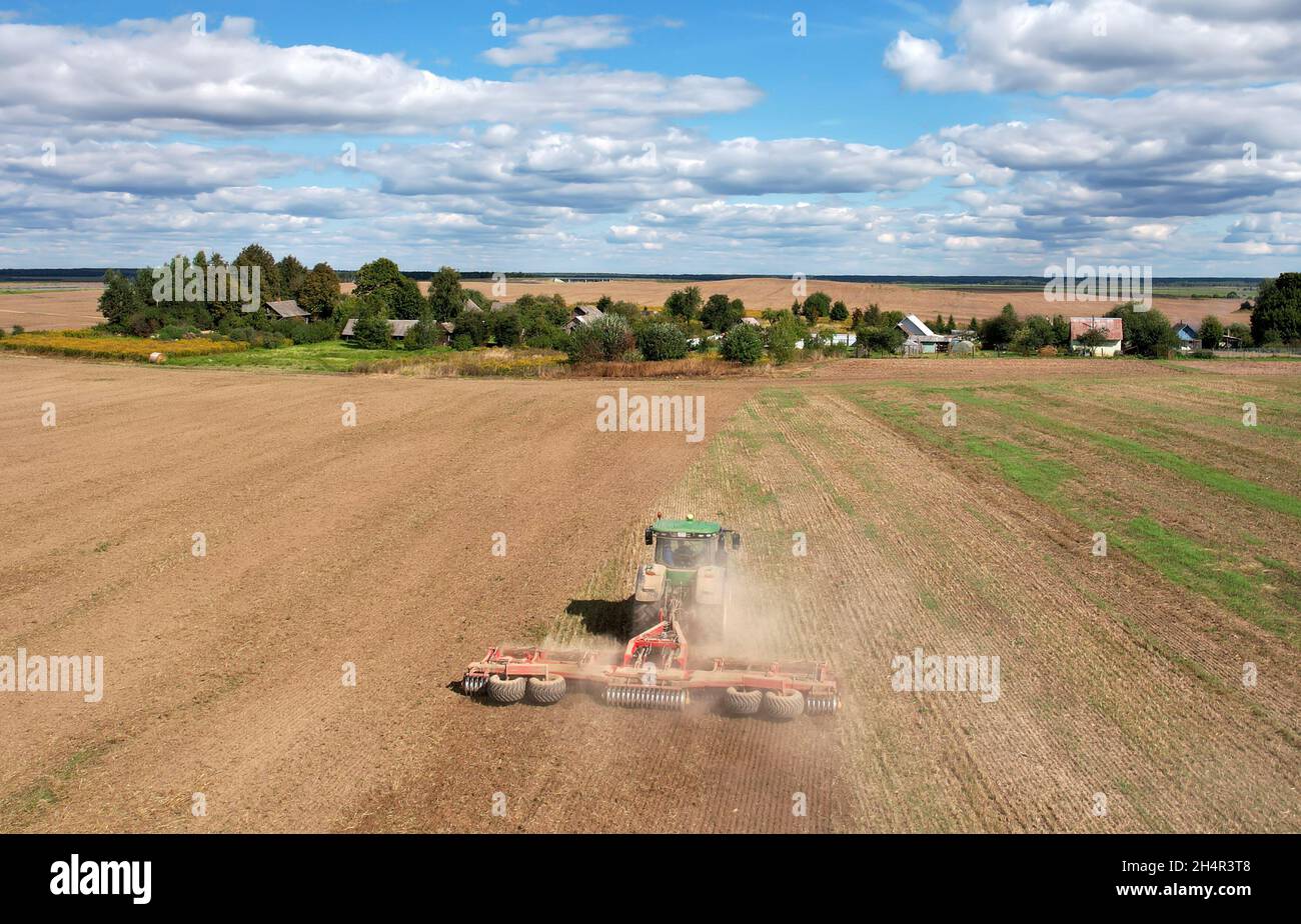 Tractor with disc cultivator on cultivating field. Soil Tillage in ...