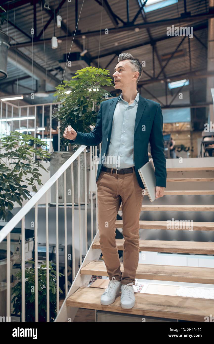 Man standing on stairs hi-res stock photography and images - Alamy