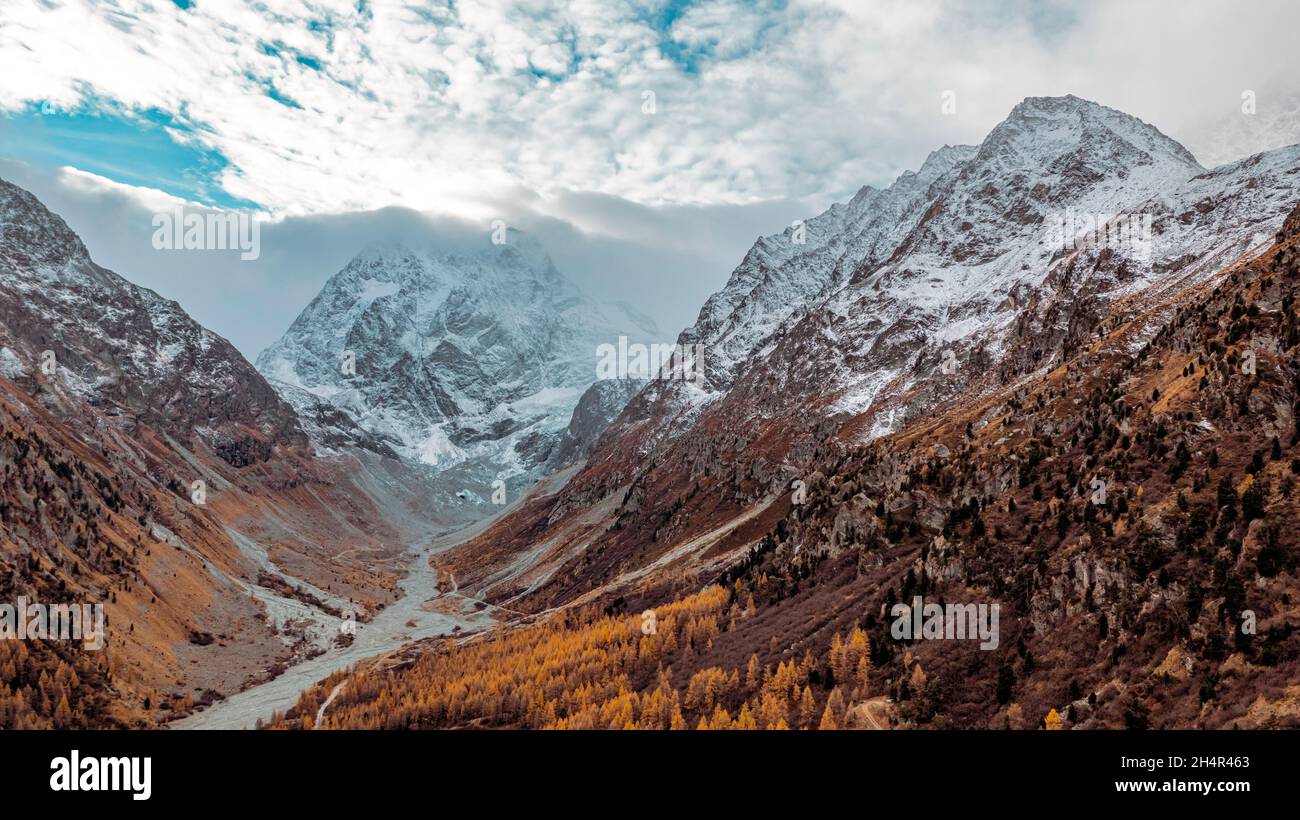 Amazing views over an high alpine valley and snow covered mountains ...