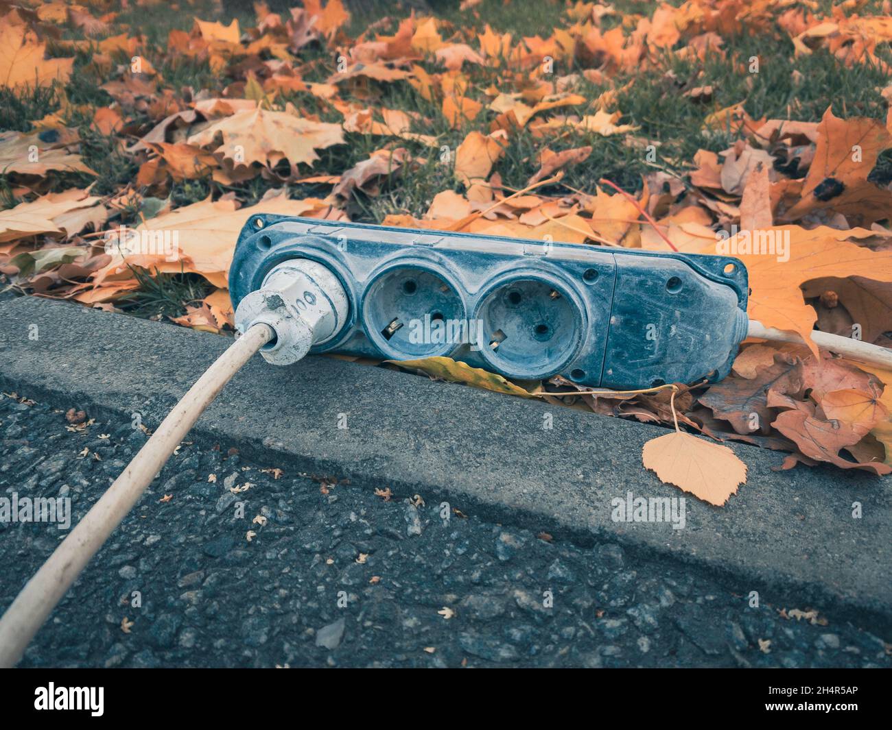 The hub of electrical outlets with the electric fork and cord on is on ...
