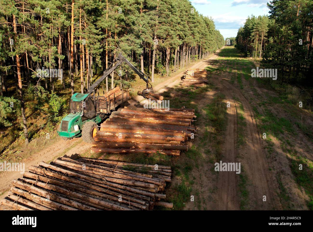 Crane forwarder machine during clearing of forested land. Wheeled ...