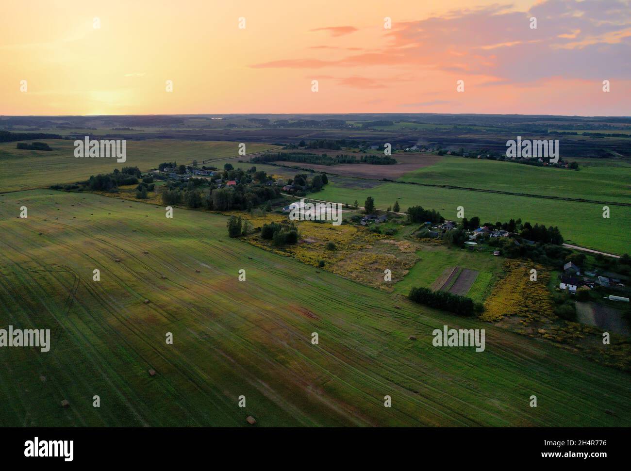 Country houses in the countryside. Aerial view of roofs of green field ...