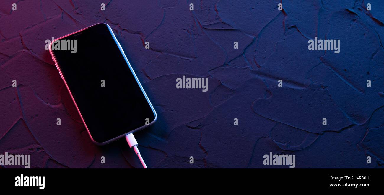 Mobile smartphone on dark red blue neon colors. Mock up.Perspective ...