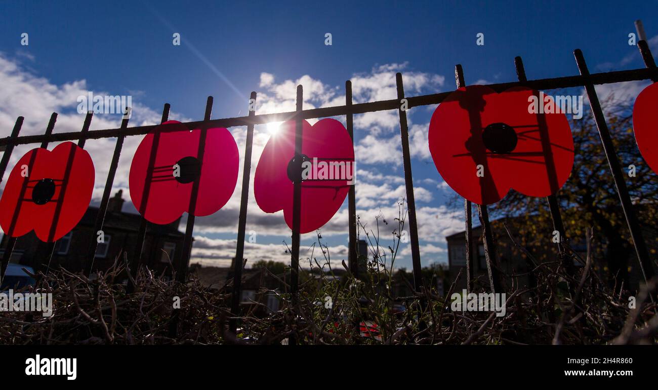 Poppy Day memorials at the war memorial in Shelf, West Yorkshire ...