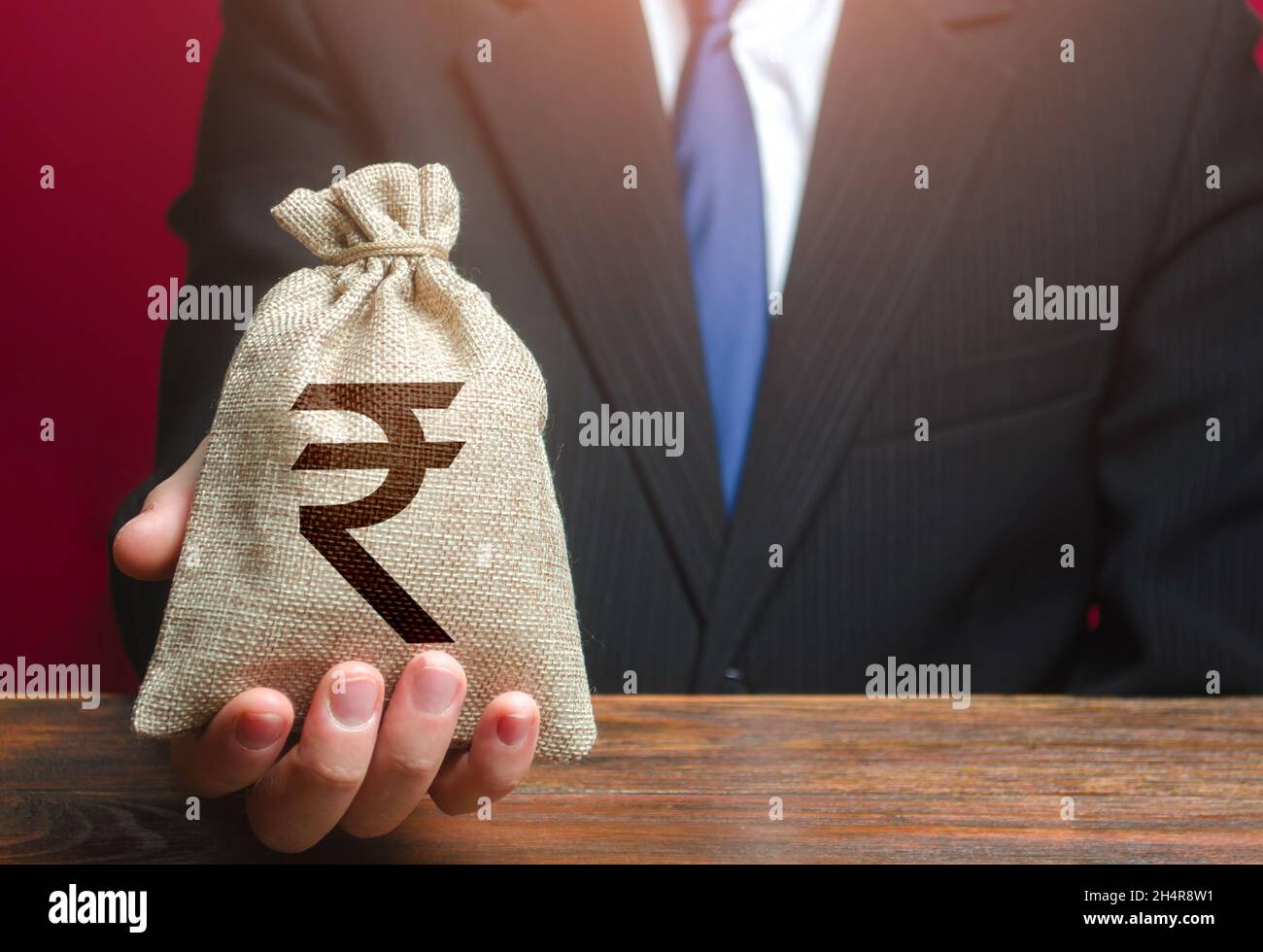 Man gives a Indian rupee money bag. Loan issuance. Financial support ...