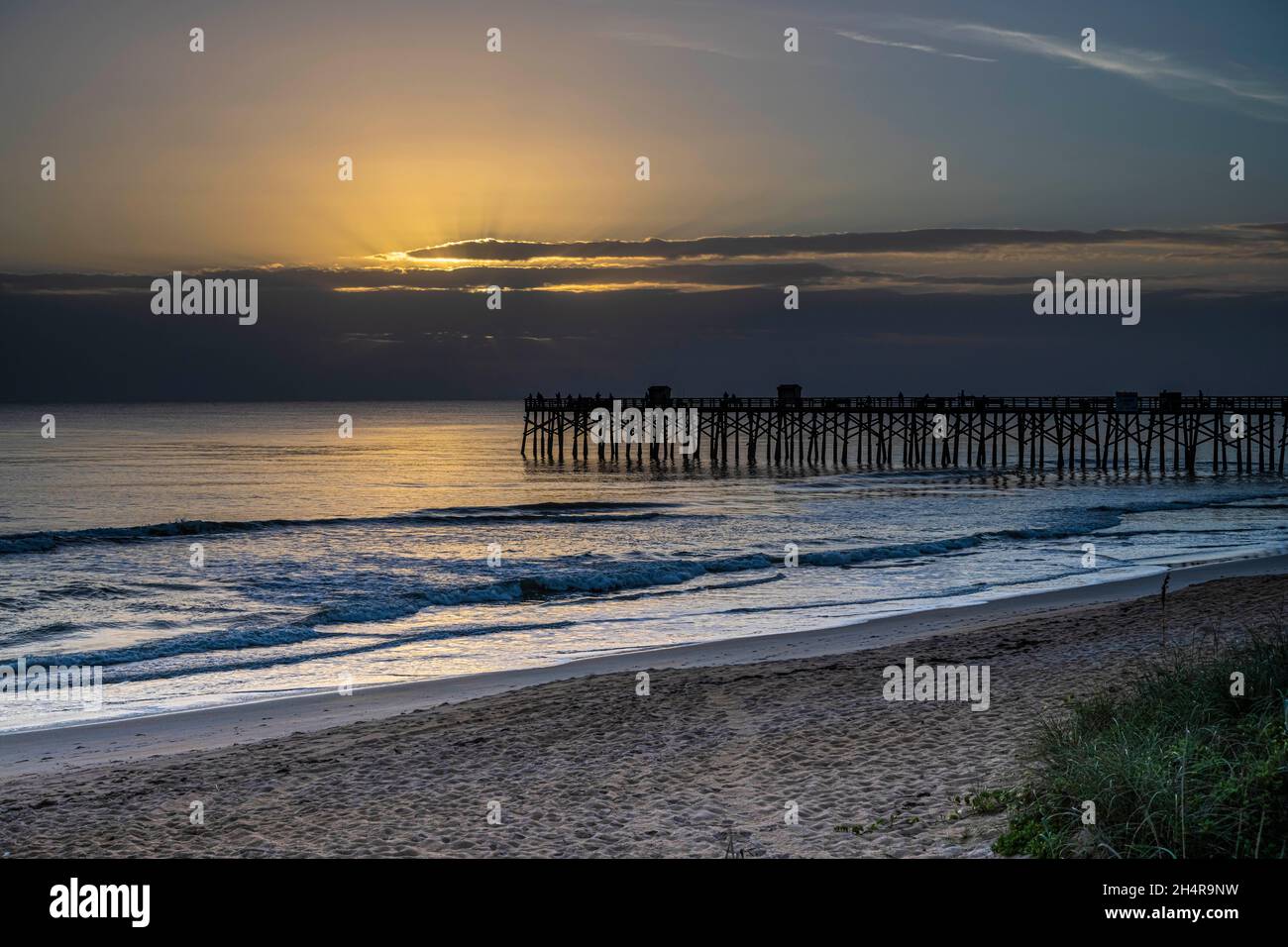 Sunbeams breaking through dark storm clouds on the horizon over the ...