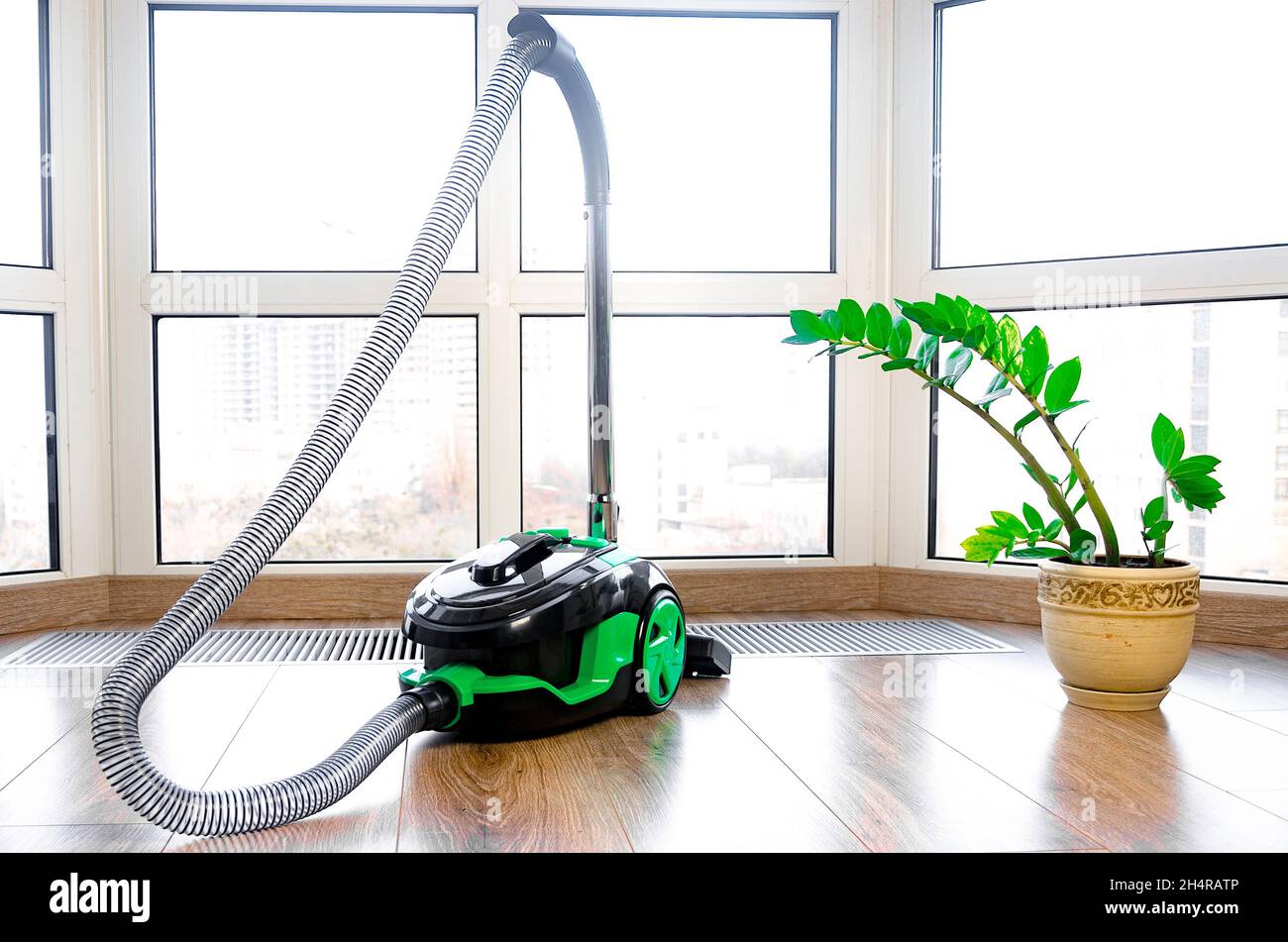 construction cleaning service. Light green vacuum cleaner on a window ...