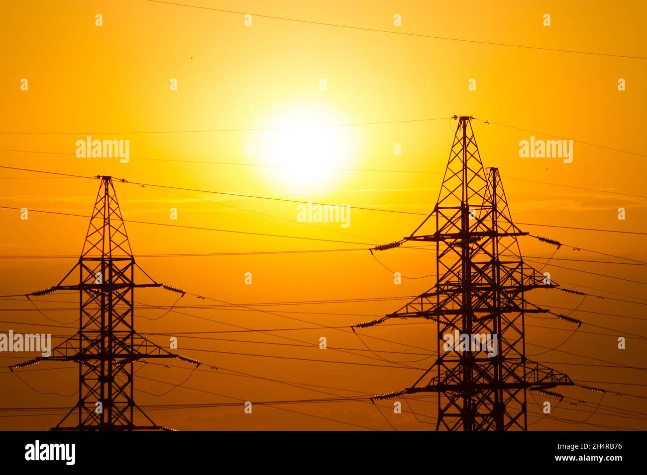 Electric towers and cabels in sunset light Stock Photo - Alamy