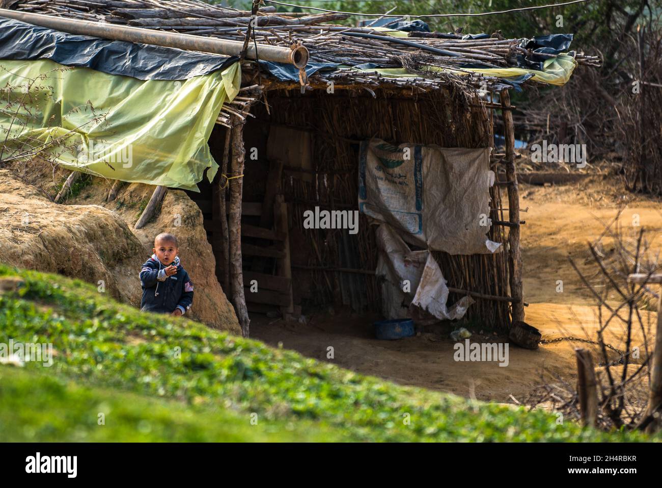 A refugee child looking at the camera with smiling Stock Photo - Alamy