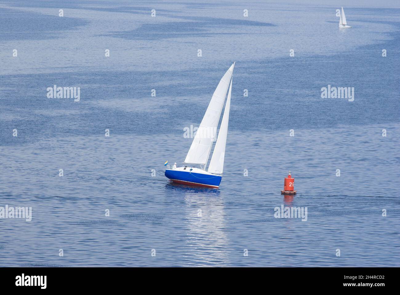 Two yachts moving to turning buoy in the sailing race on Dnepr river ...