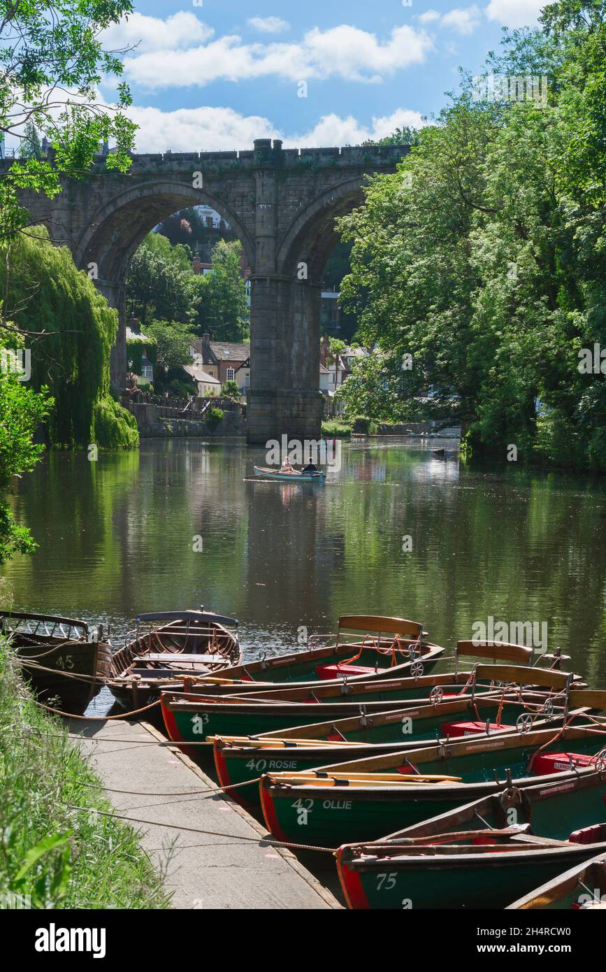 Yorkshire River Nidd, view in summer of people rowing below the viaduct ...