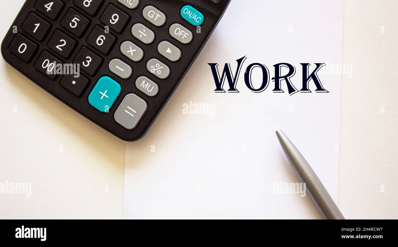 Work text on white background with calculator Stock Photo - Alamy