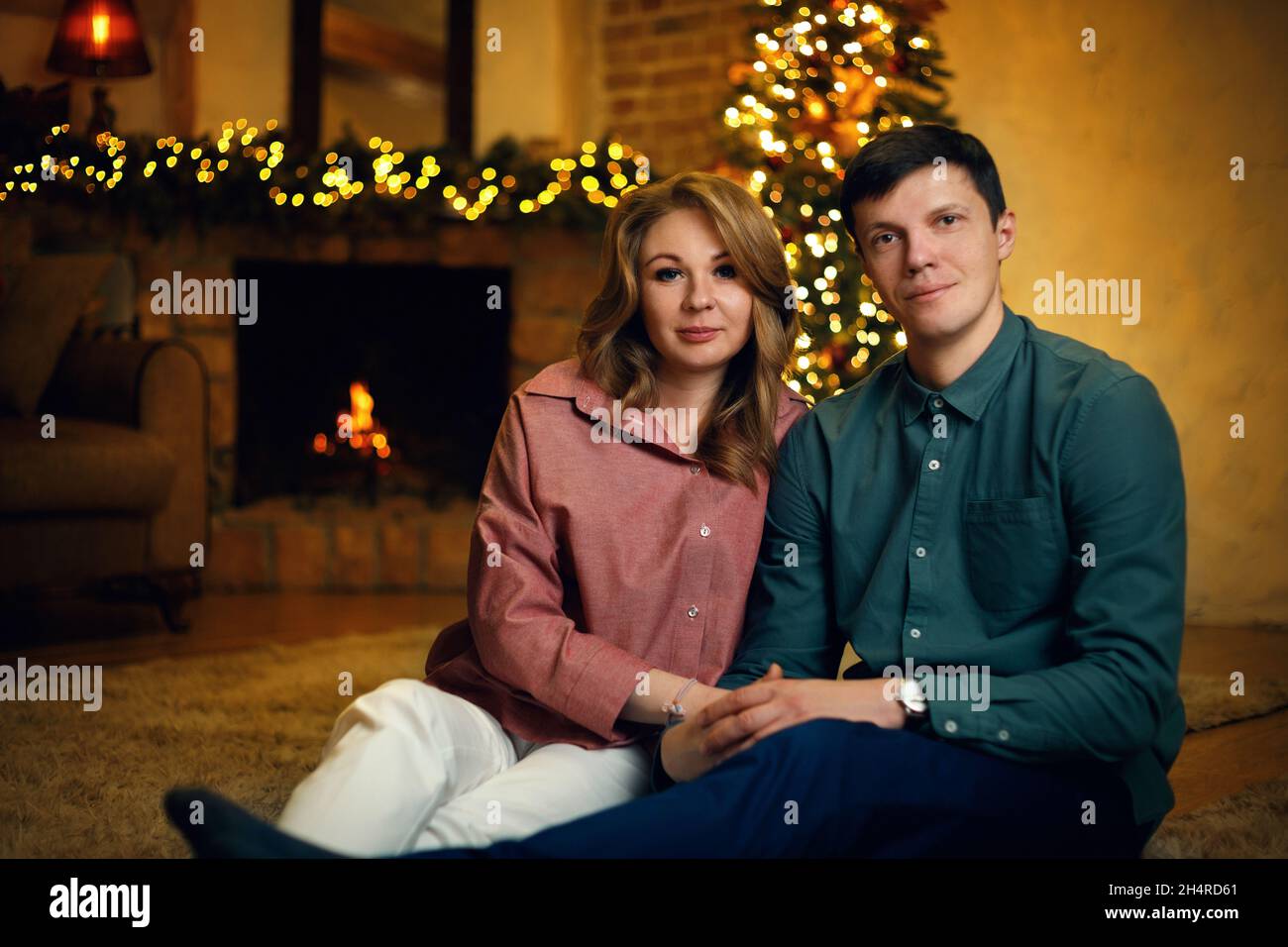Beautiful middle aged caucasian couple posing in new year interior with ...
