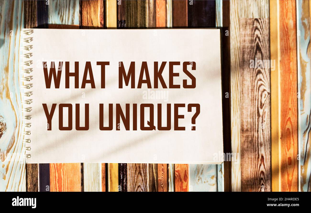 What makes you unique The phrase is written on a notepad and striped ...