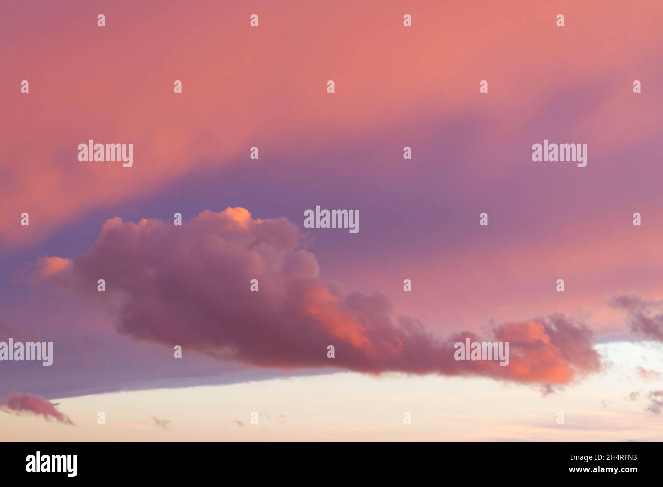 cloudscape with pink colors. Tropical sunset Stock Photo - Alamy