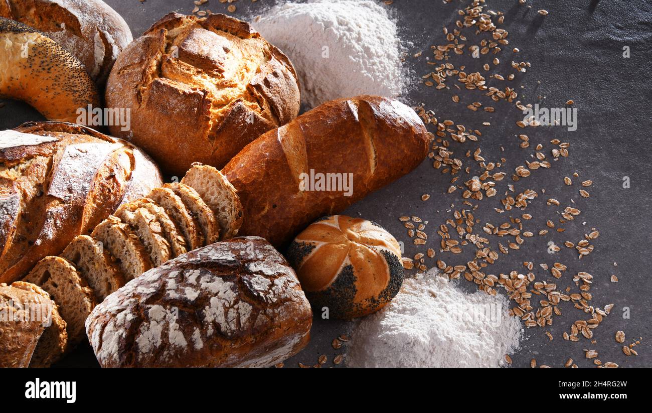 Assorted bakery products including loafs of bread and rolls Stock Photo ...