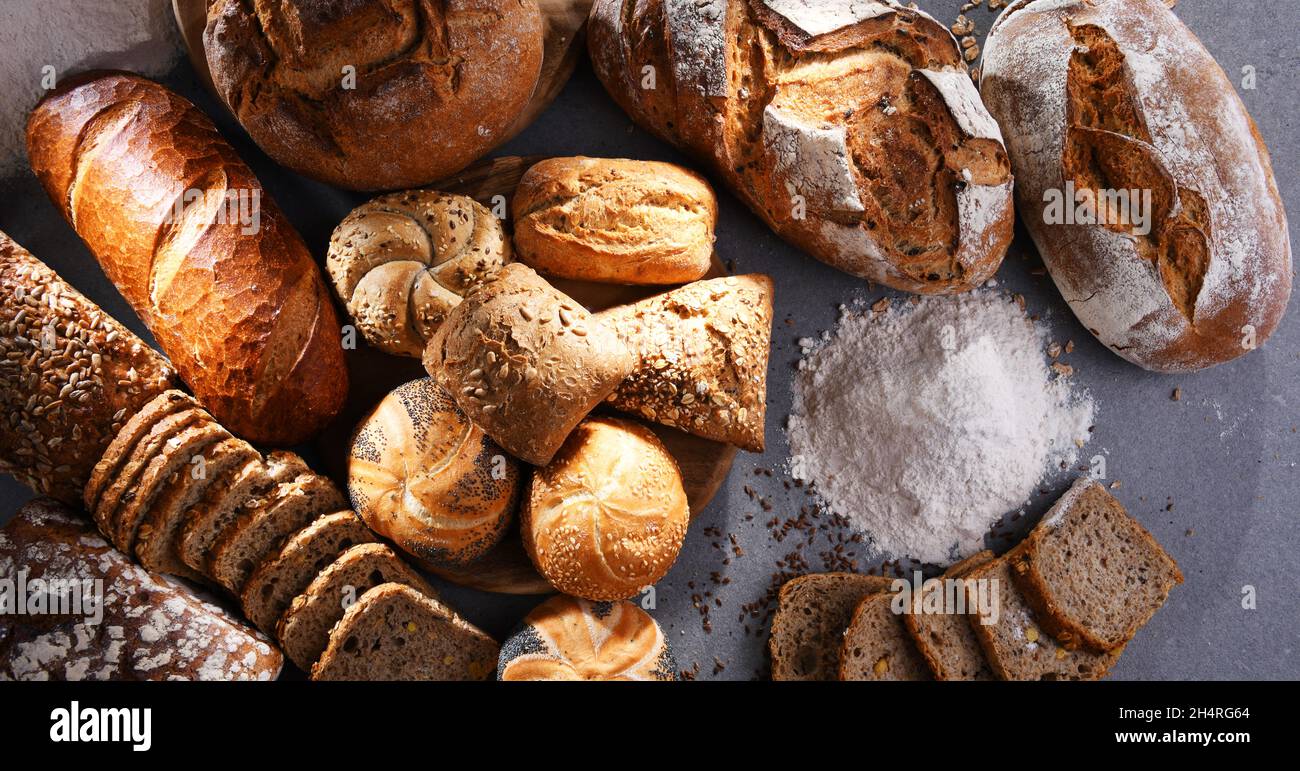 Assorted bakery products including loafs of bread and rolls Stock Photo ...