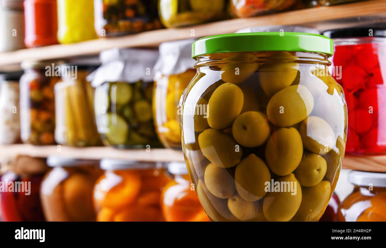 Jars with variety of marinated vegetables and fruits. Preserved food ...