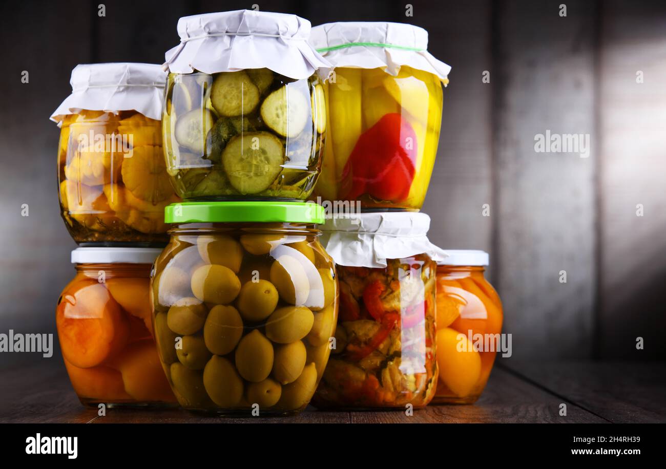 Jars with variety of marinated vegetables and fruits. Preserved food ...
