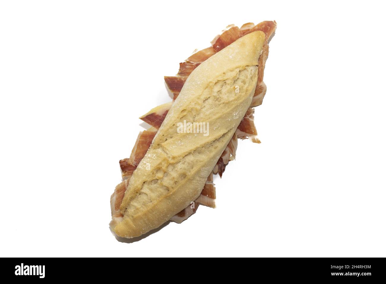 Traditional Spanish bocadillo ham sandwich with a crusty bread isolated ...
