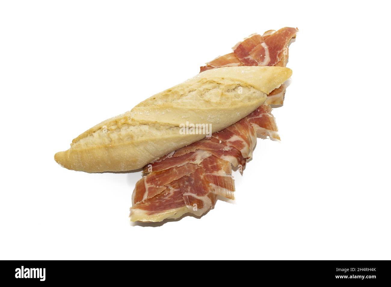 Traditional Spanish bocadillo ham sandwich with a crusty bread isolated ...