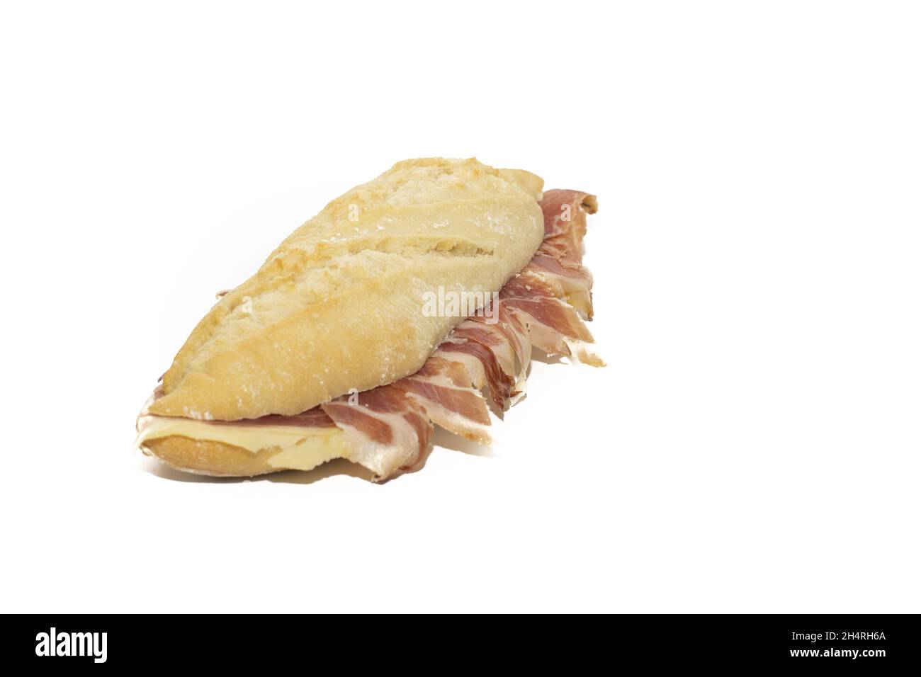Traditional Spanish bocadillo ham sandwich with a crusty bread isolated ...