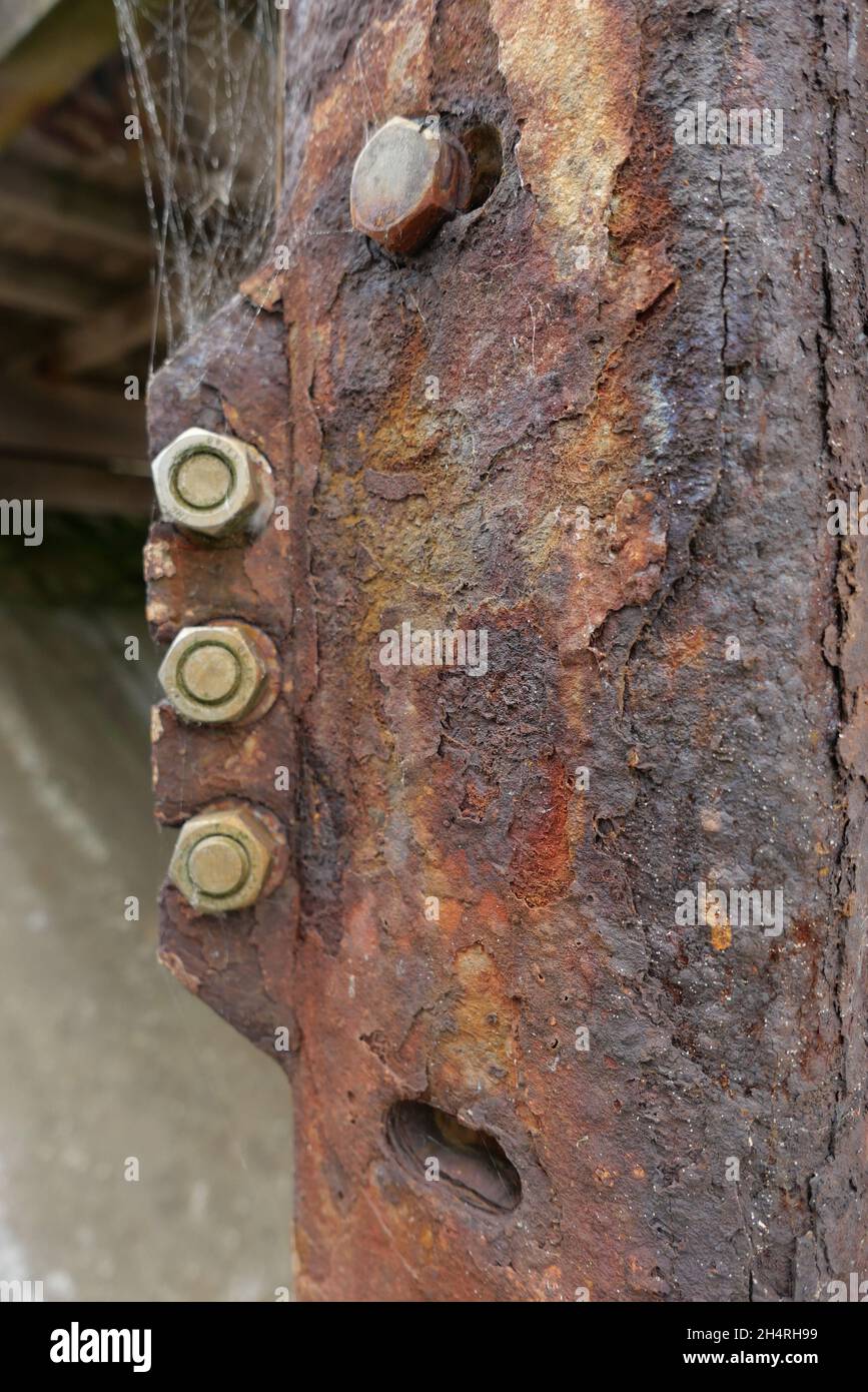 Close up of rusty old metal pillar with steel nuts and bolts Stock ...